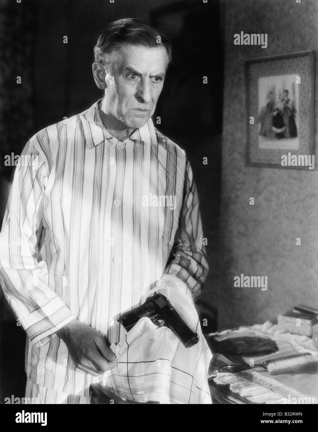 Man holding a handgun in a handkerchief looking distraught Stock Photo ...