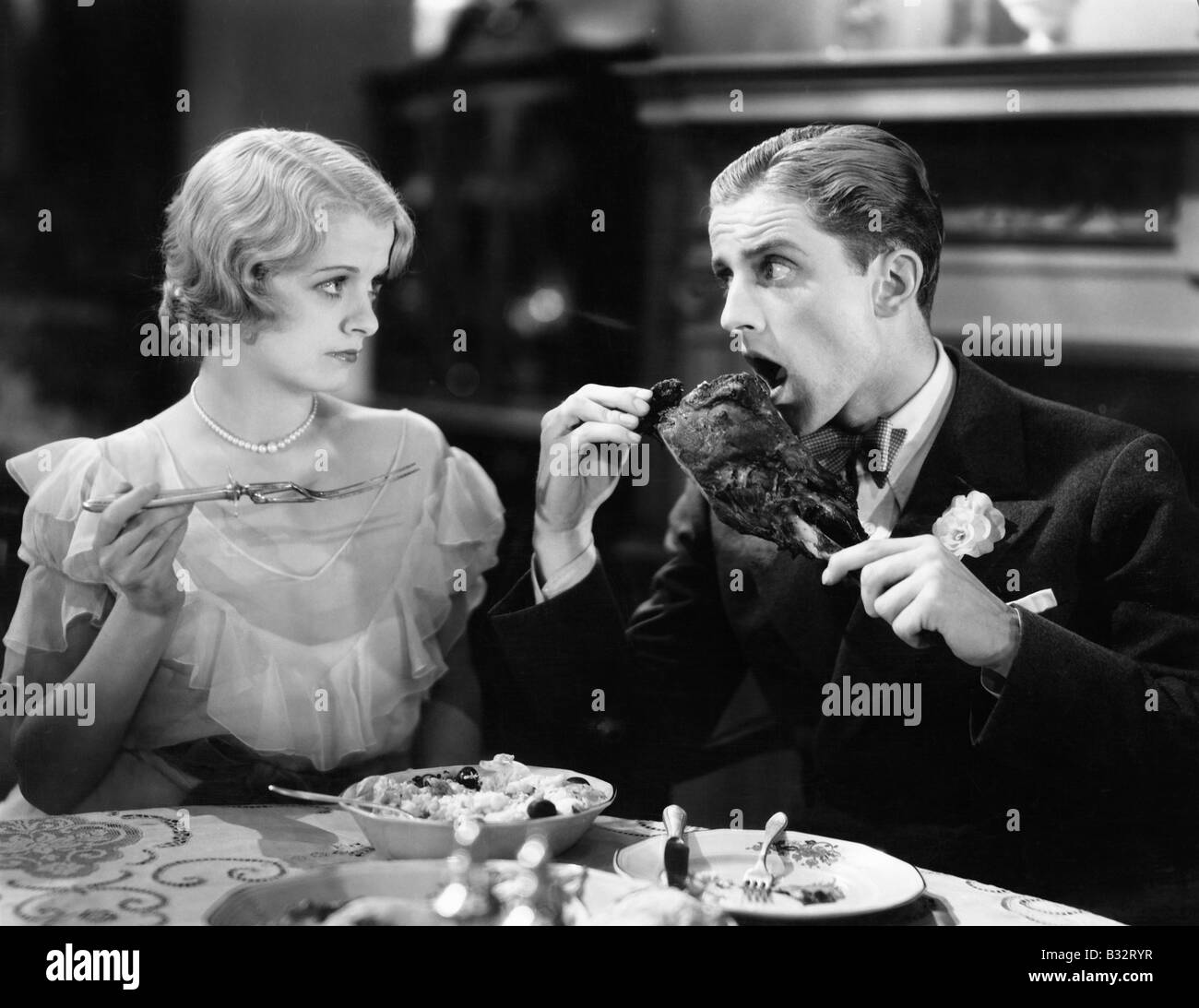 Man woman dining table Black and White Stock Photos & Images - Alamy