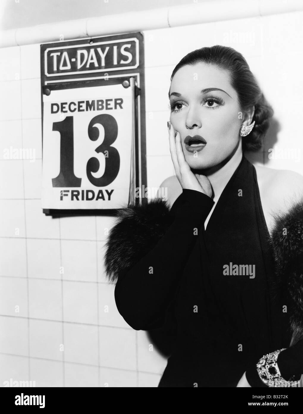 Young woman looking shocked after seeing Friday the 13th on a calendar ...