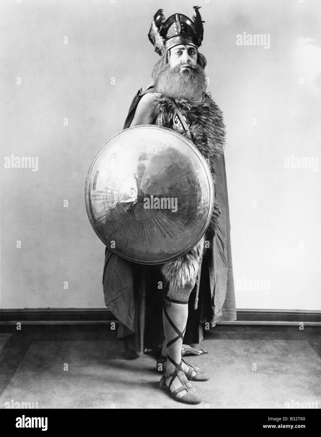 Portrait of a Viking warrior standing and holding a shield Stock Photo ...