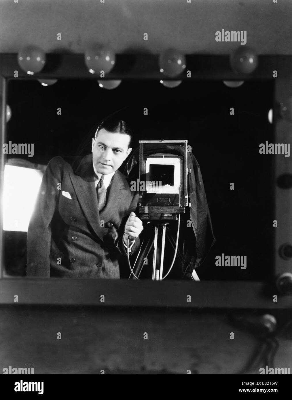 Portrait of a man standing with a large format camera Stock Photo - Alamy