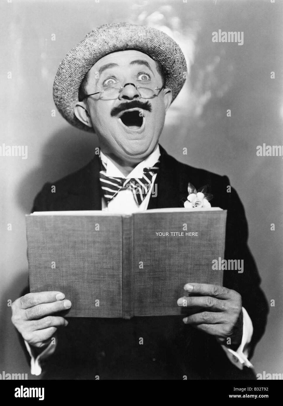 Man holding a book and singing Stock Photo - Alamy