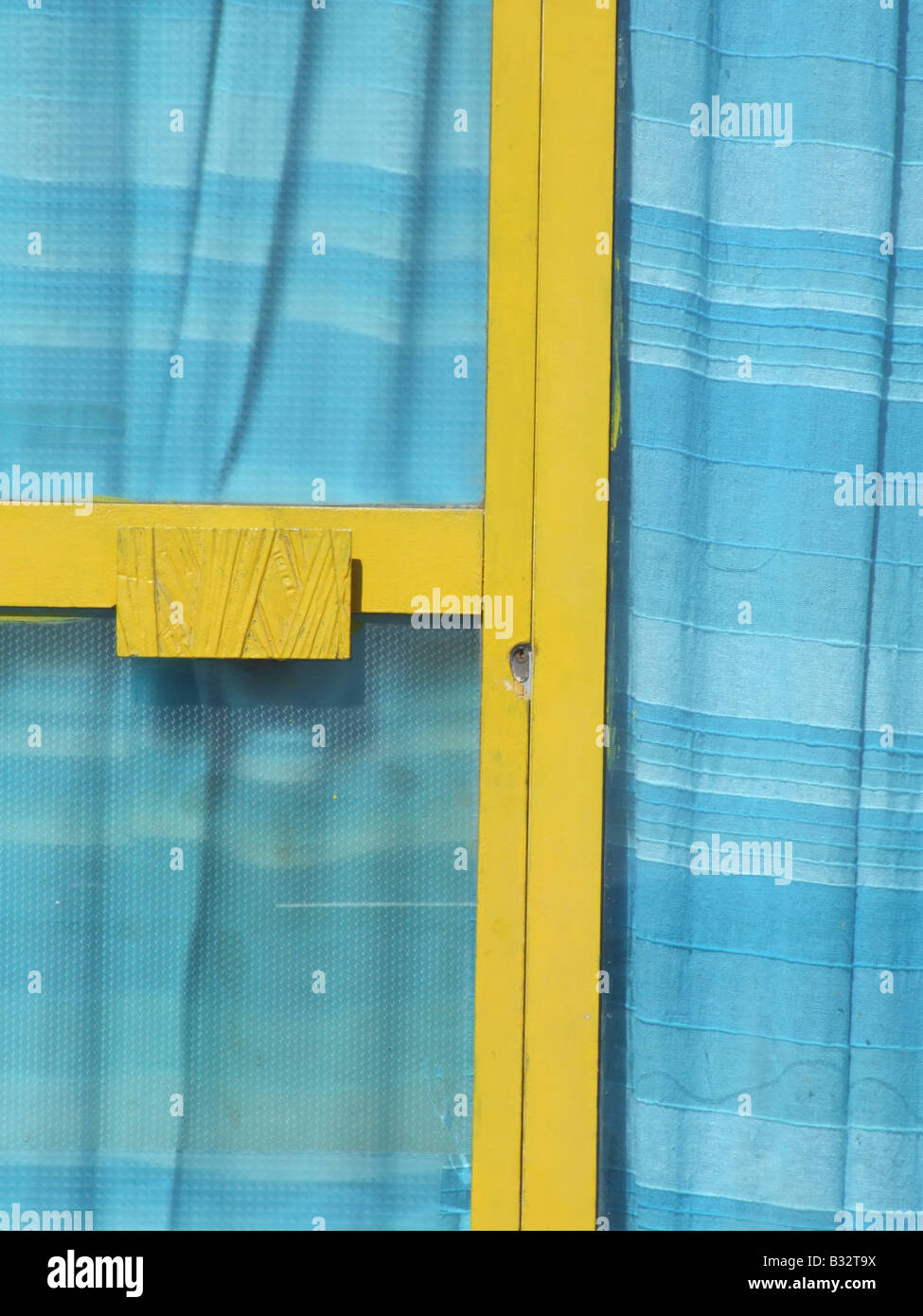 yellow window with blue curtains in sun Stock Photo - Alamy