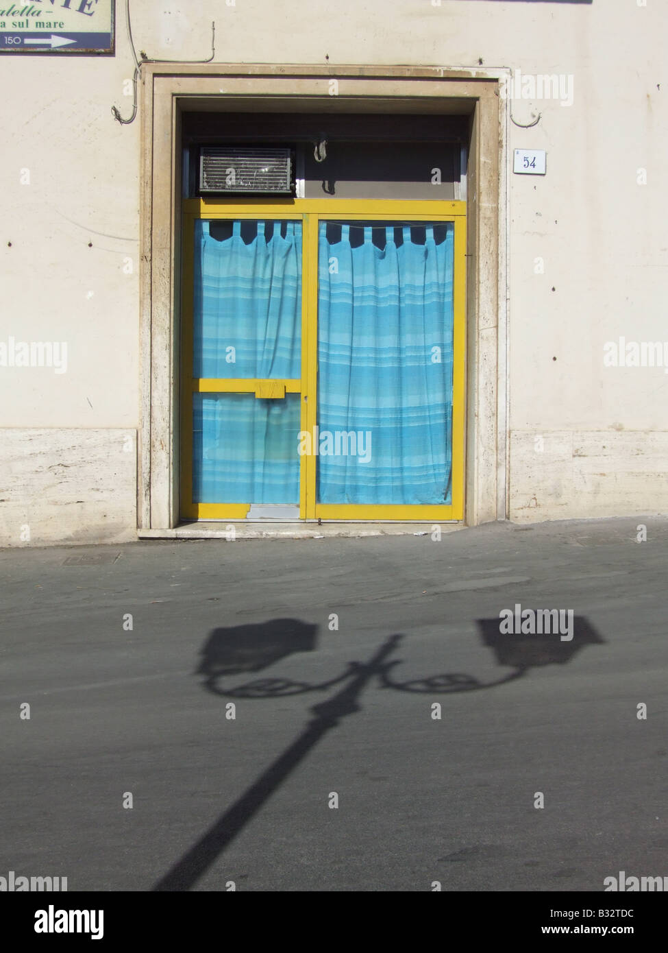 yellow window with blue curtains in sun Stock Photo - Alamy