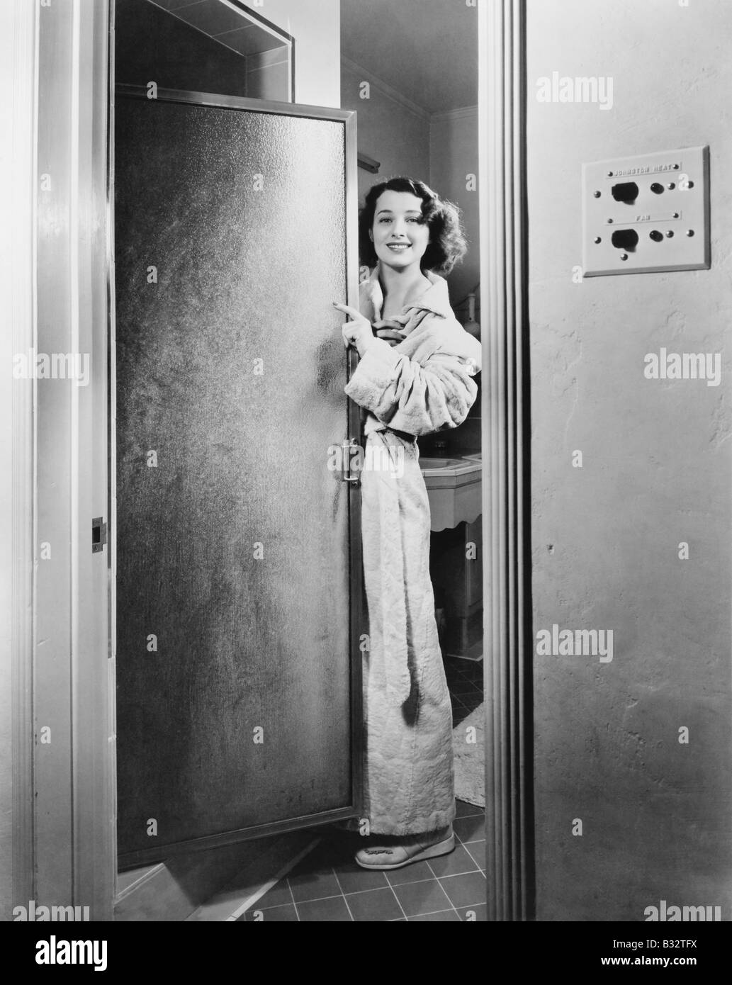 Woman entering bathroom hi-res stock photography and images - Alamy