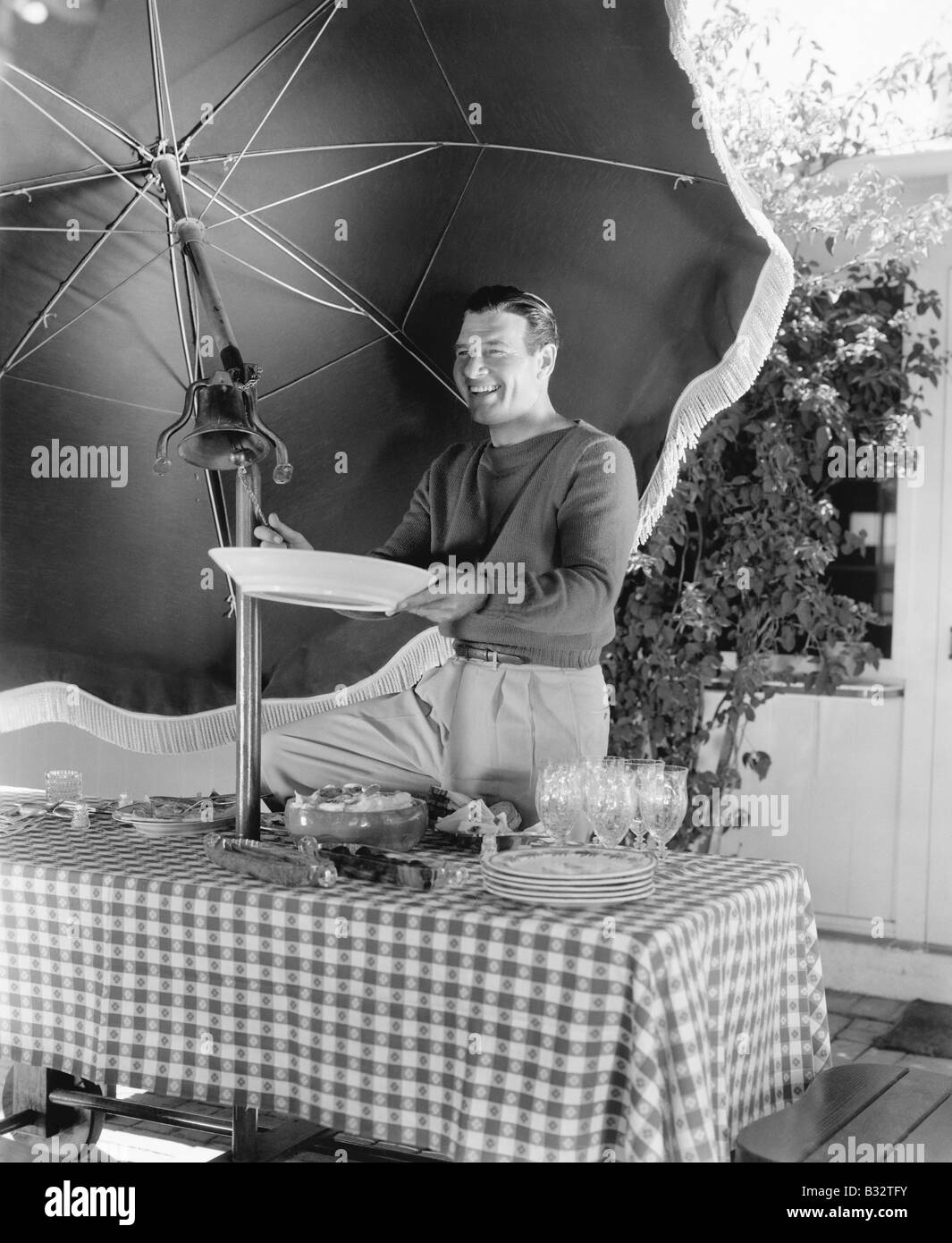 Man standing by chairs Black and White Stock Photos & Images - Alamy