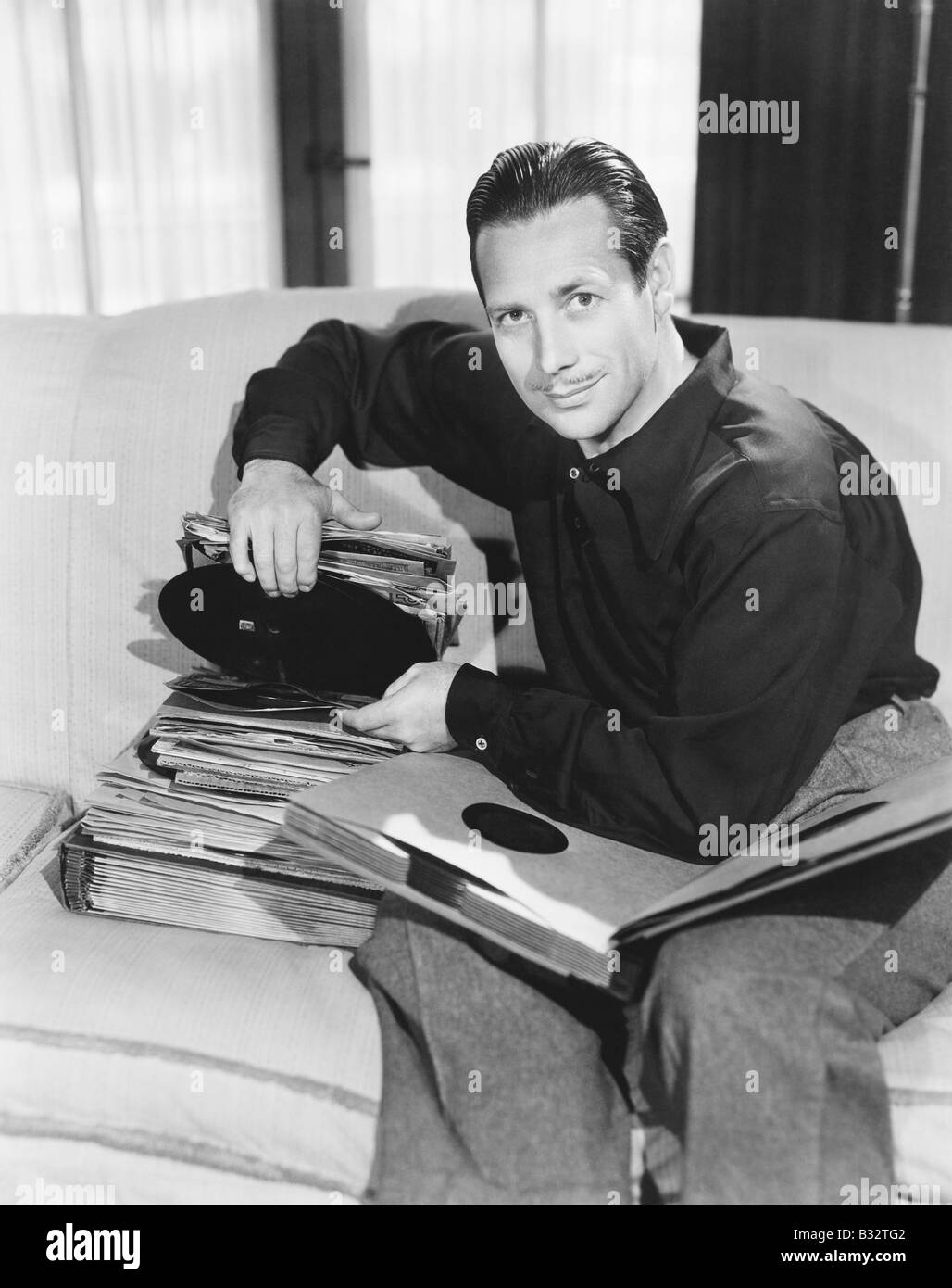 Man sitting on record collection hi-res stock photography and images ...