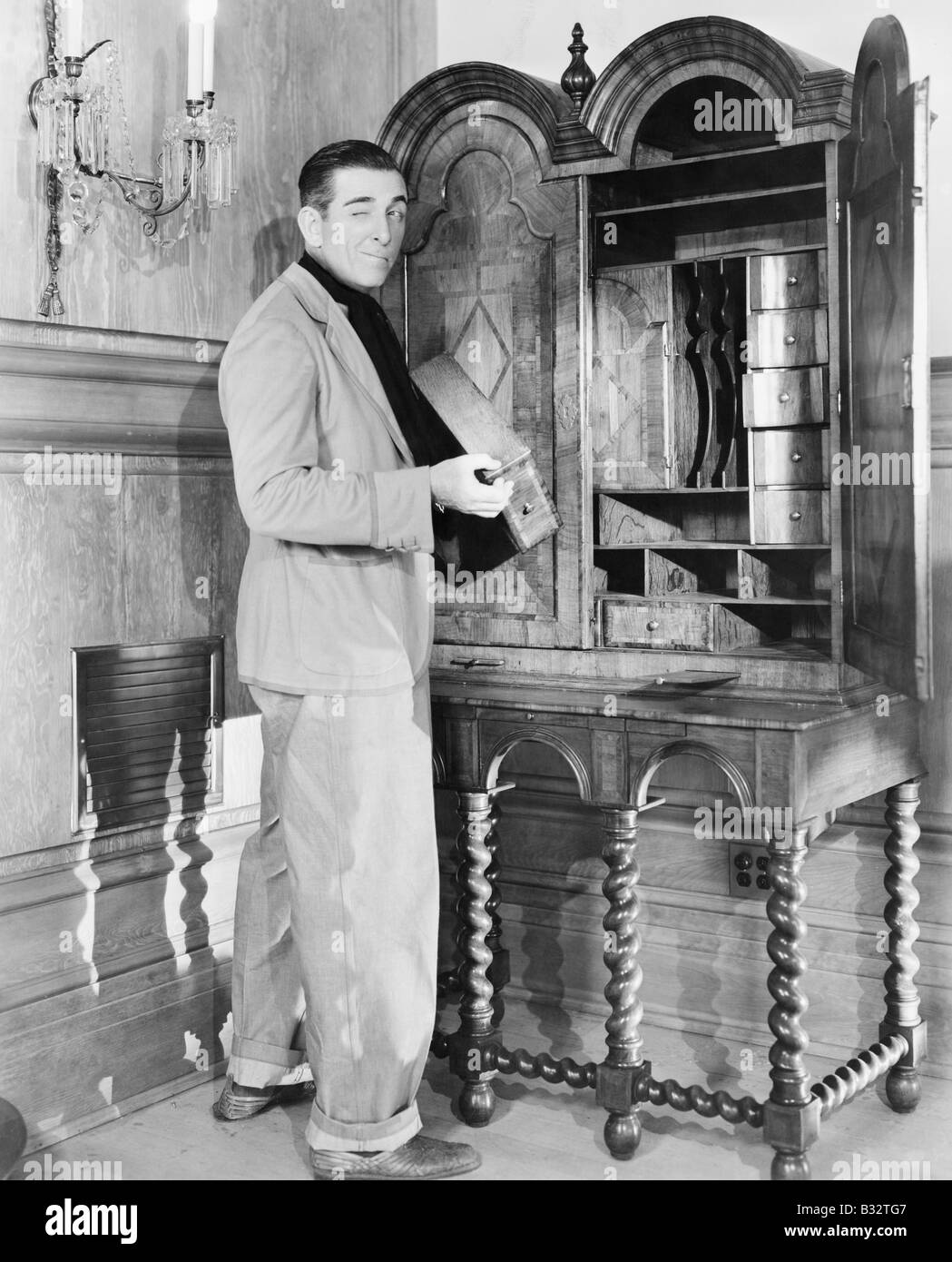 Profile of a man holding a drawer and winking Stock Photo - Alamy