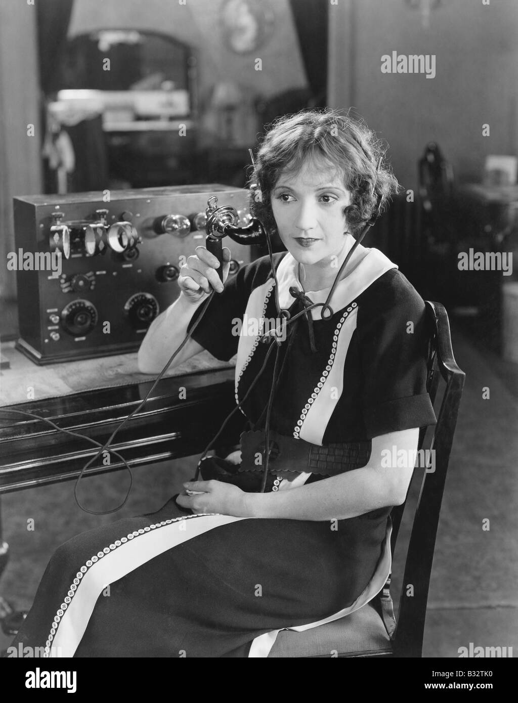 Switchboard operator sitting at telephone switchboard and talking Stock ...