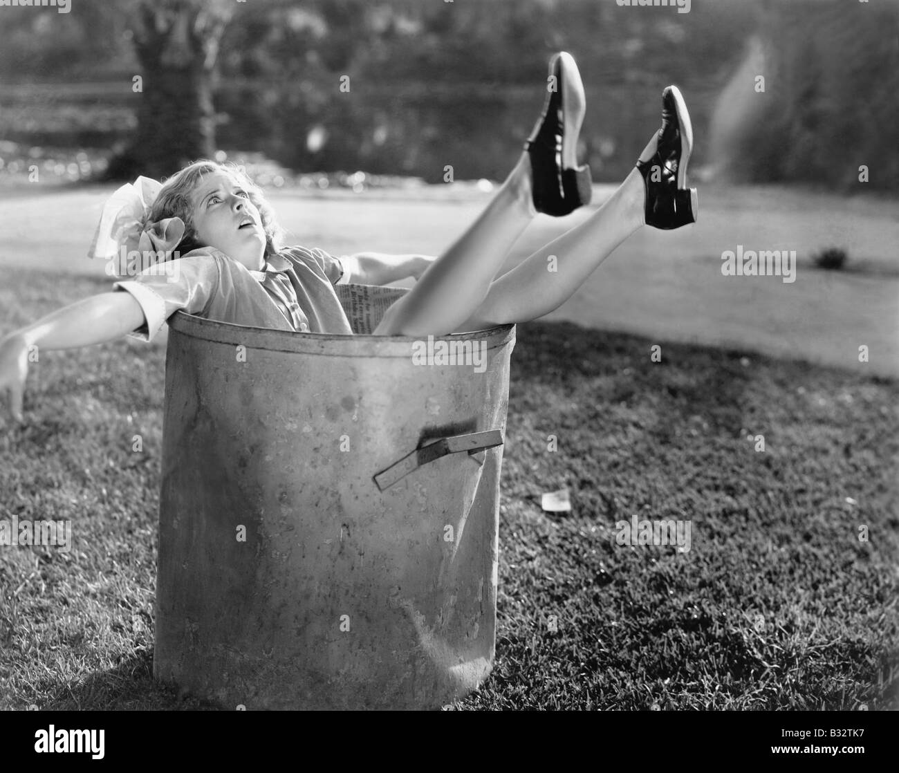 Woman fallen in the garbage bin at the roadside Stock Photo - Alamy