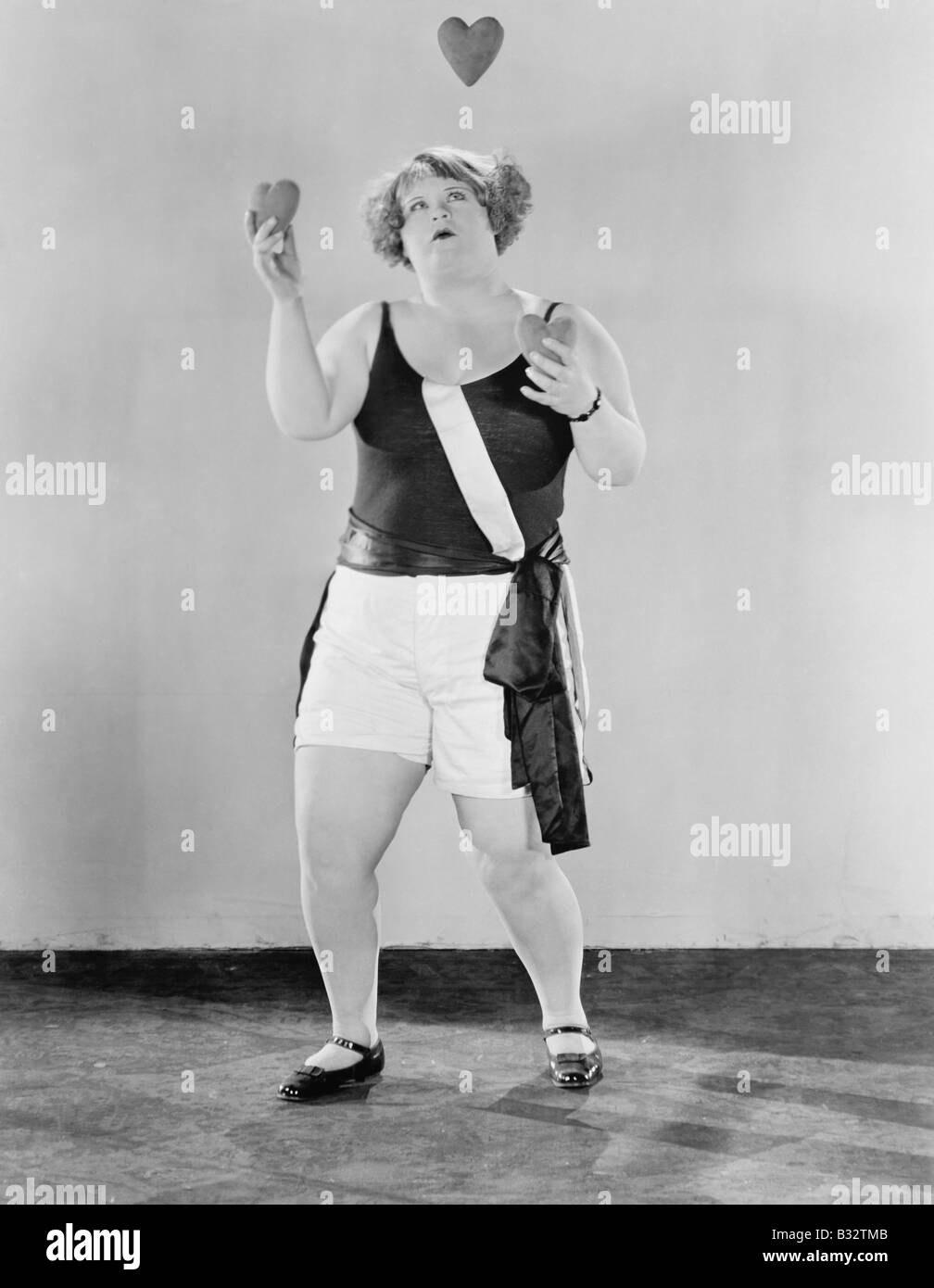 Woman juggling with heart shaped objects Stock Photo - Alamy