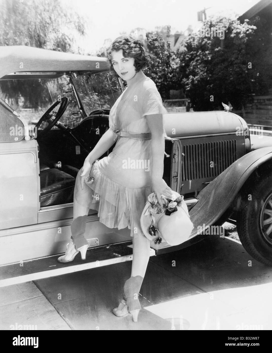 Young woman getting into her car for a drive in the country Stock Photo ...