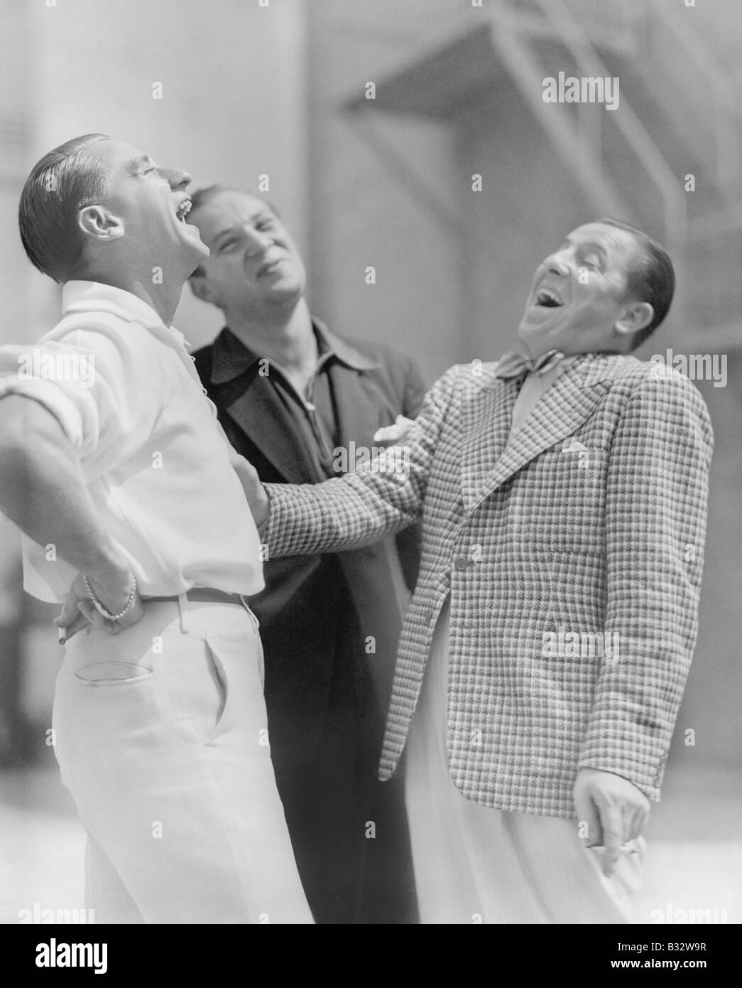 Three men standing together and laughing Stock Photo - Alamy Three men standing together and laughing Stock Photo - Alamy