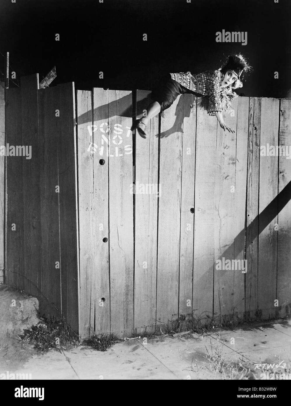 Person climbing over fence Black and White Stock Photos & Images - Alamy