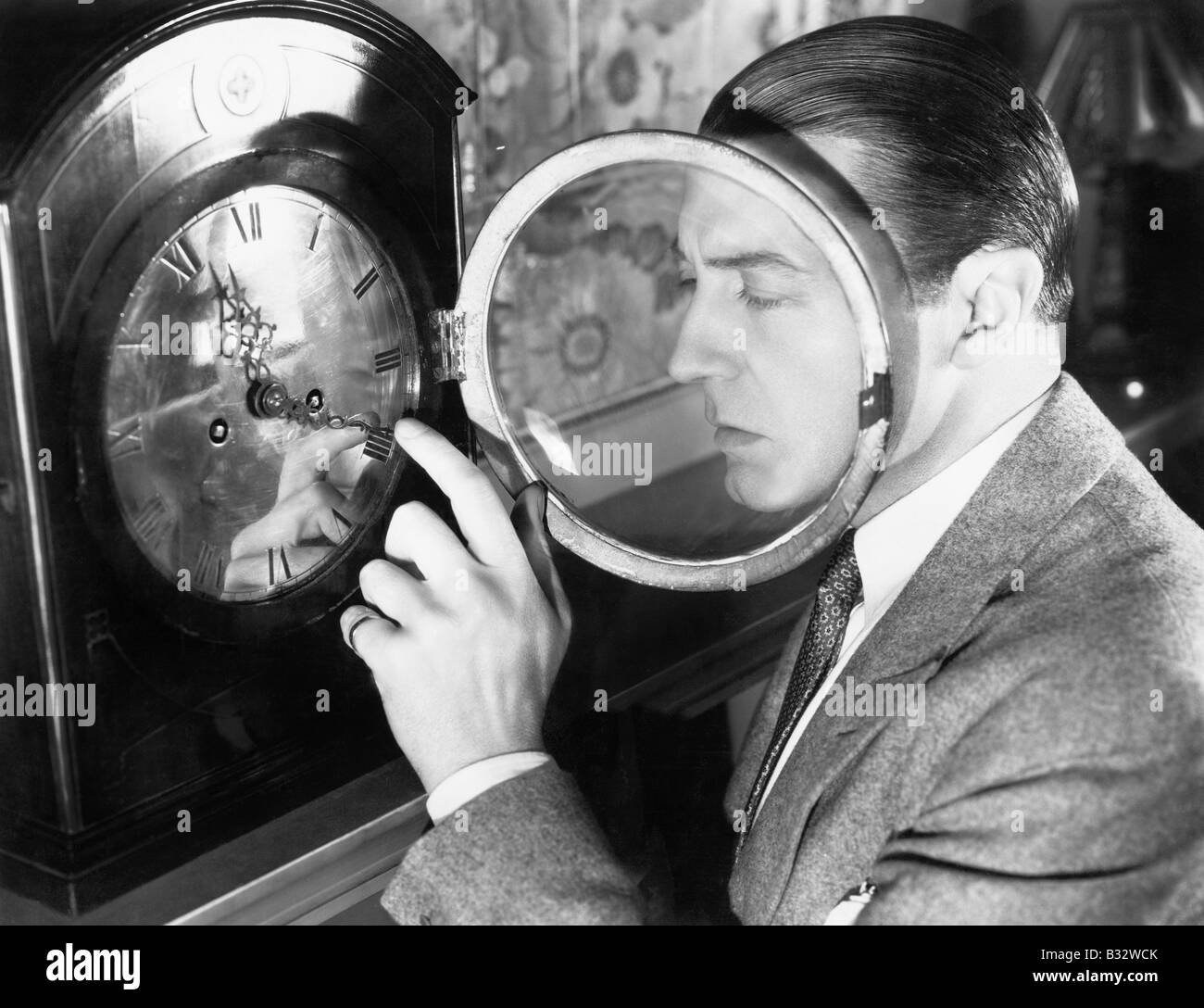 Man setting a clock Stock Photo - Alamy