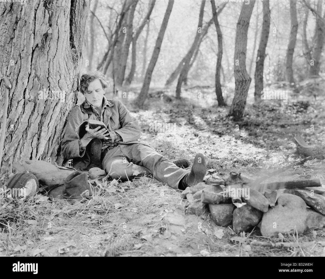 Man sitting by fire Black and White Stock Photos & Images - Alamy