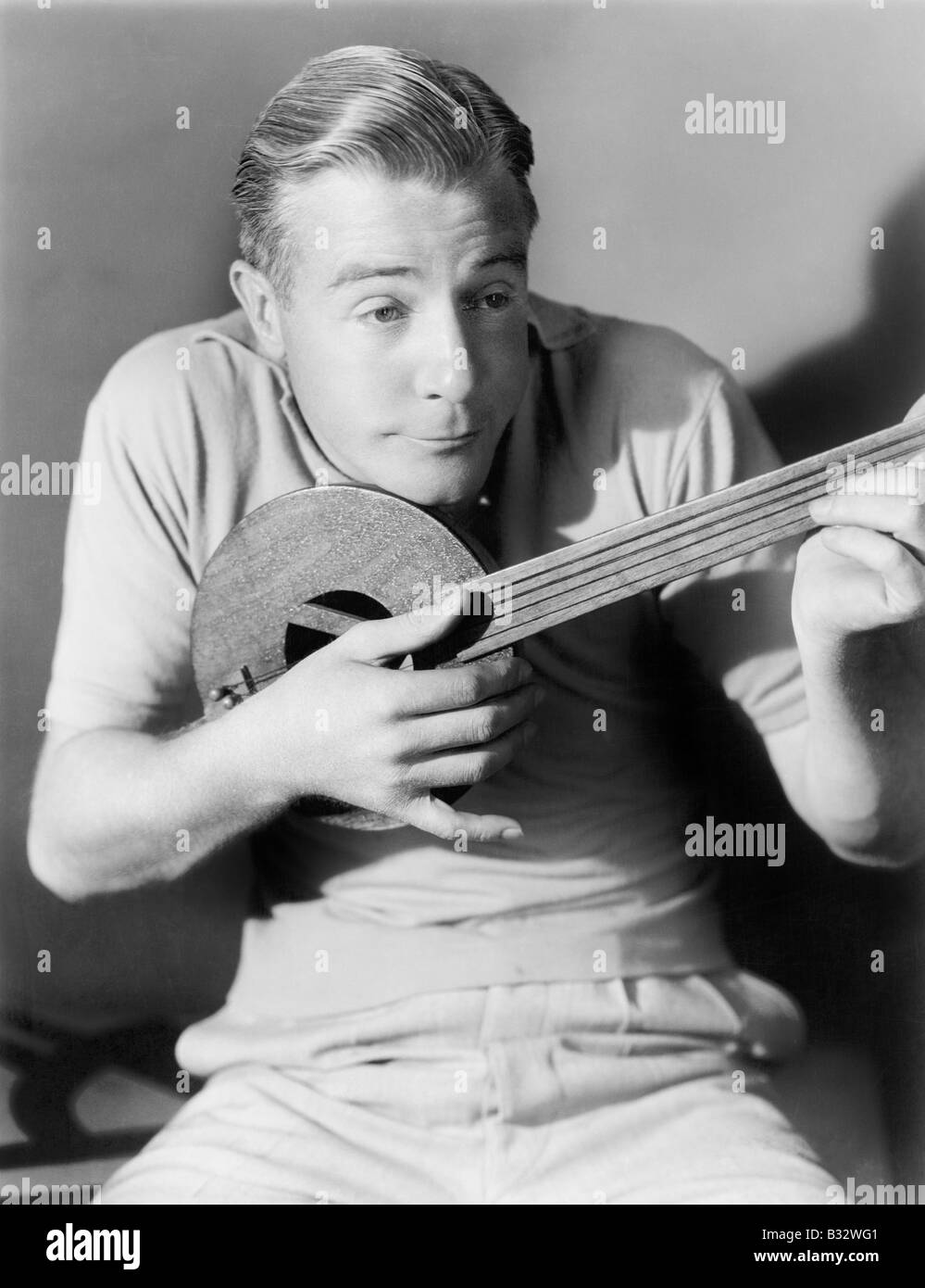 Man playing a lute, a small instrument Stock Photo - Alamy