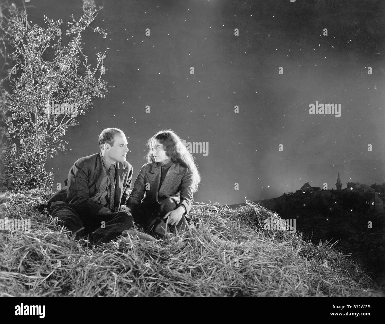 Sitting on hay stack Black and White Stock Photos & Images - Alamy