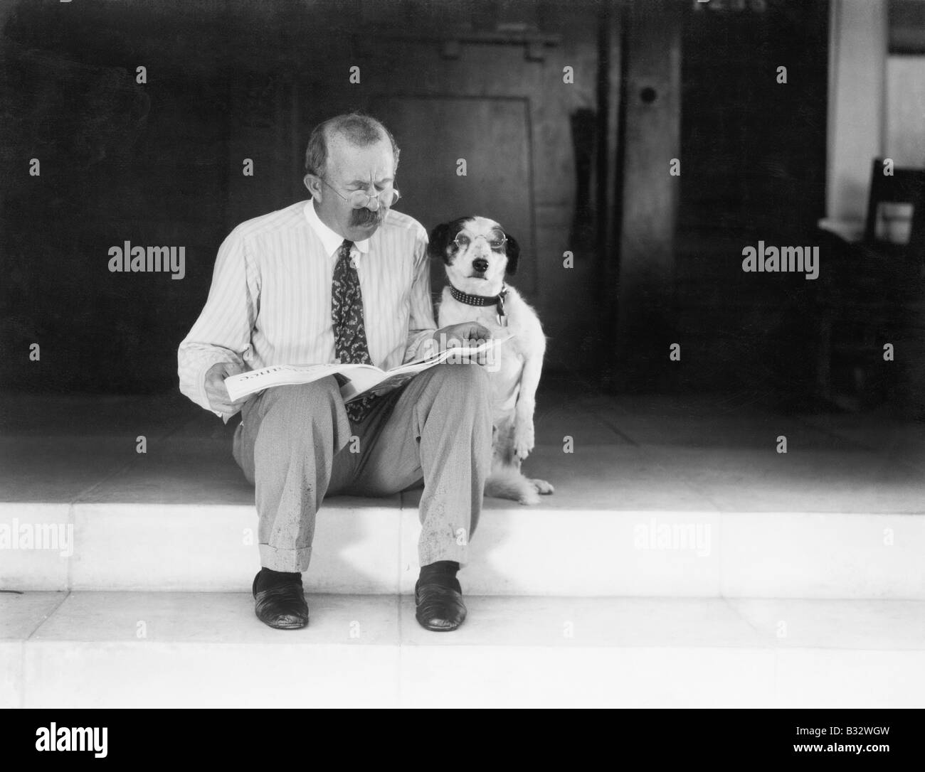 Man sits reading on Black and White Stock Photos & Images - Alamy