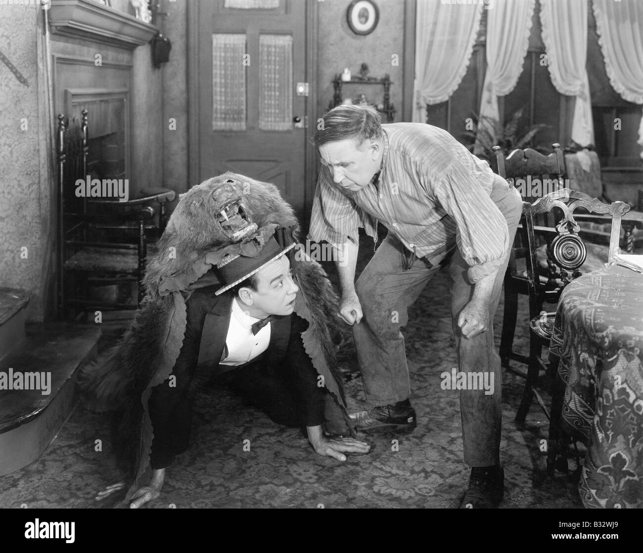 Man in a living room hiding under a bear skin Stock Photo - Alamy