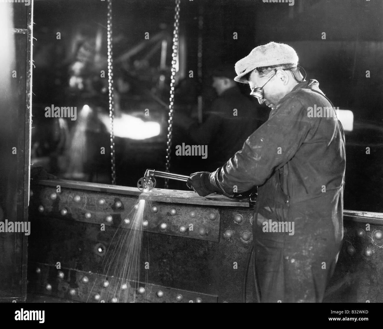 Iron worker welding Stock Photo - Alamy