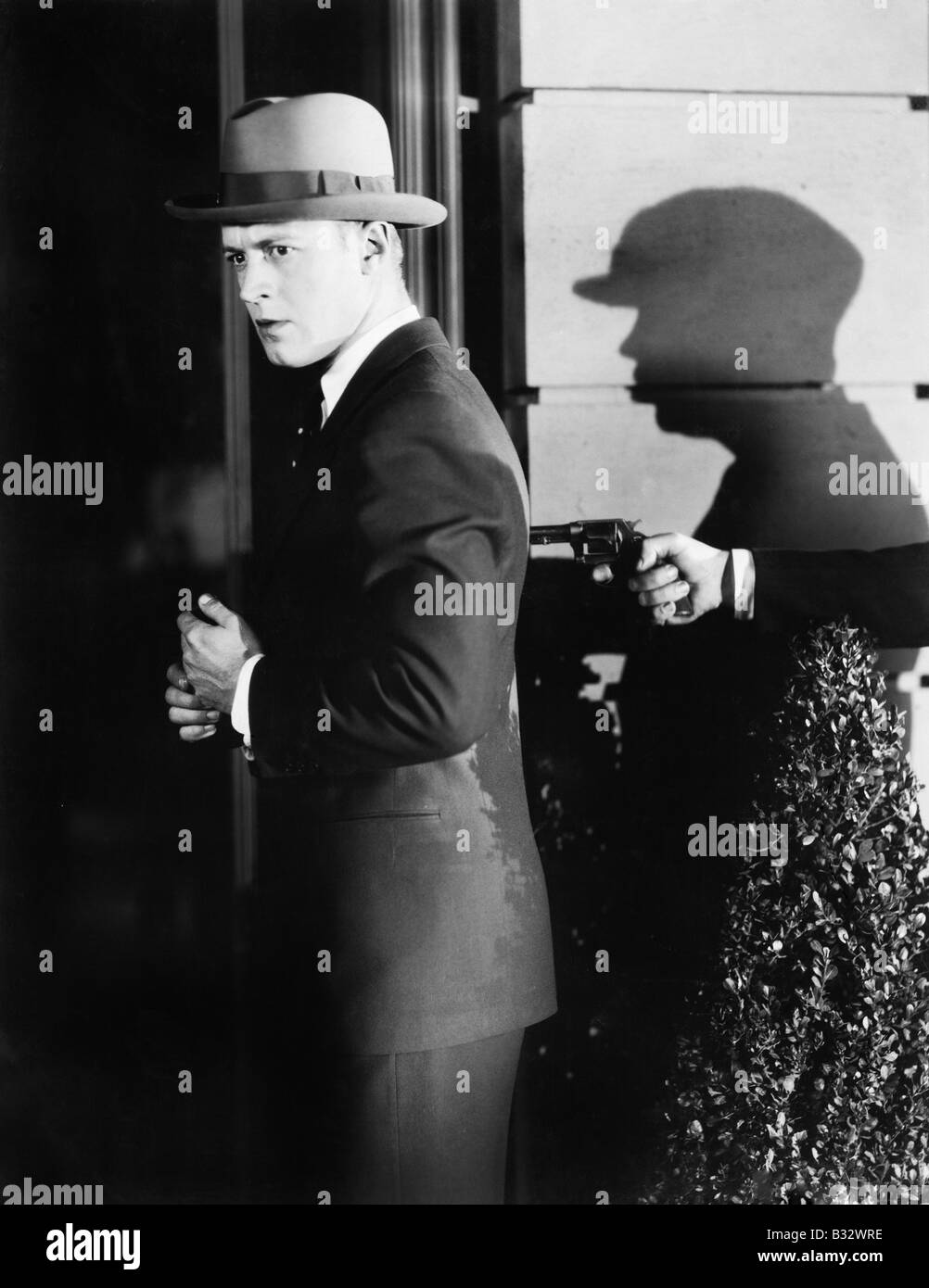 Man in a suit with a gun in his hand hi-res stock photography and ...