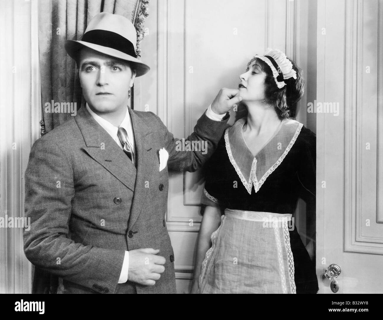 Man pinching the chin of a housekeeper Stock Photo - Alamy