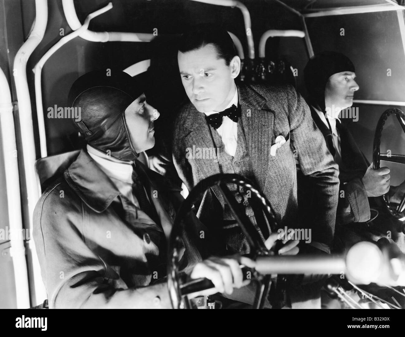 Three men inside of the cockpit of an airplane Stock Photo - Alamy