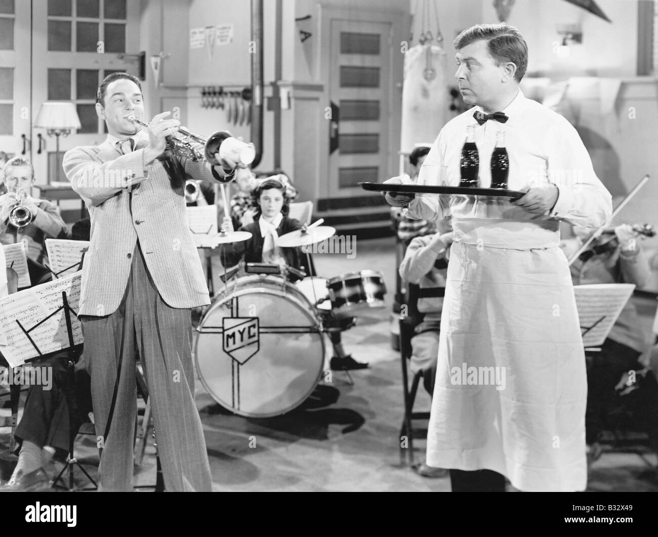 Trombone player looking at a waiter in a bar Stock Photo - Alamy