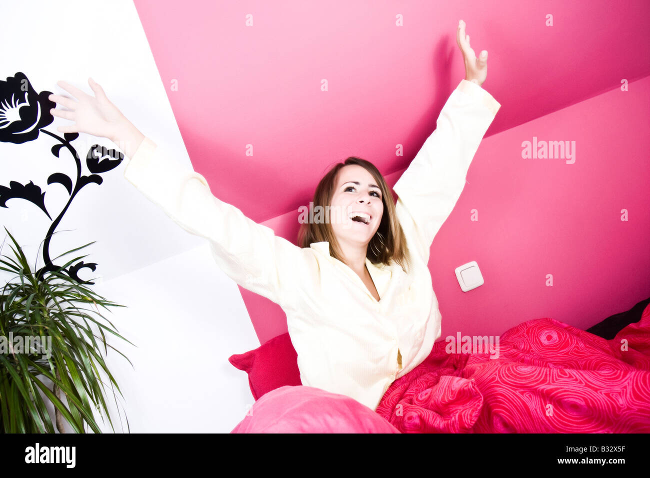 girl stretching after awakening in bed Stock Photo - Alamy