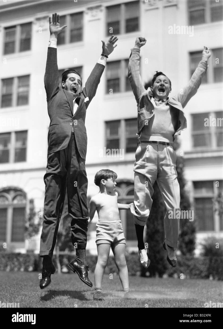 A little boy pretending to lift two grown men Stock Photo - Alamy