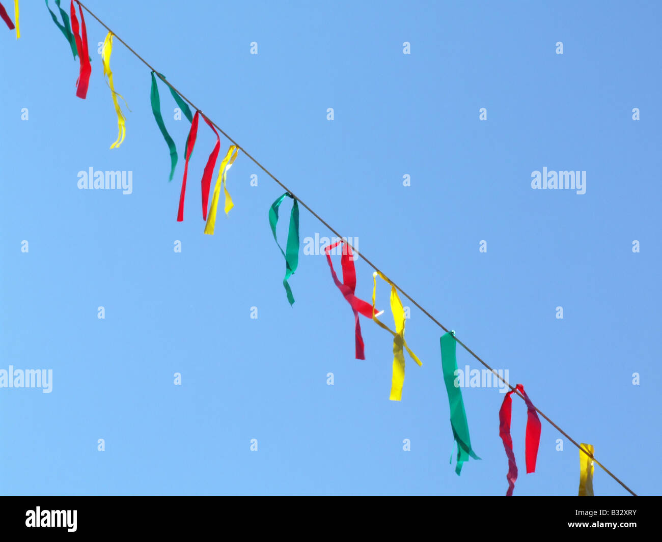 colourful carnival bunting decorations in blue sky Stock Photo - Alamy