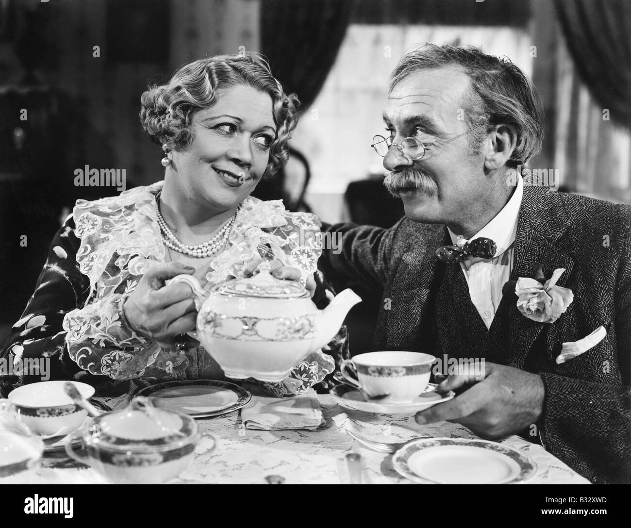 Couple sitting together having tea Stock Photo - Alamy