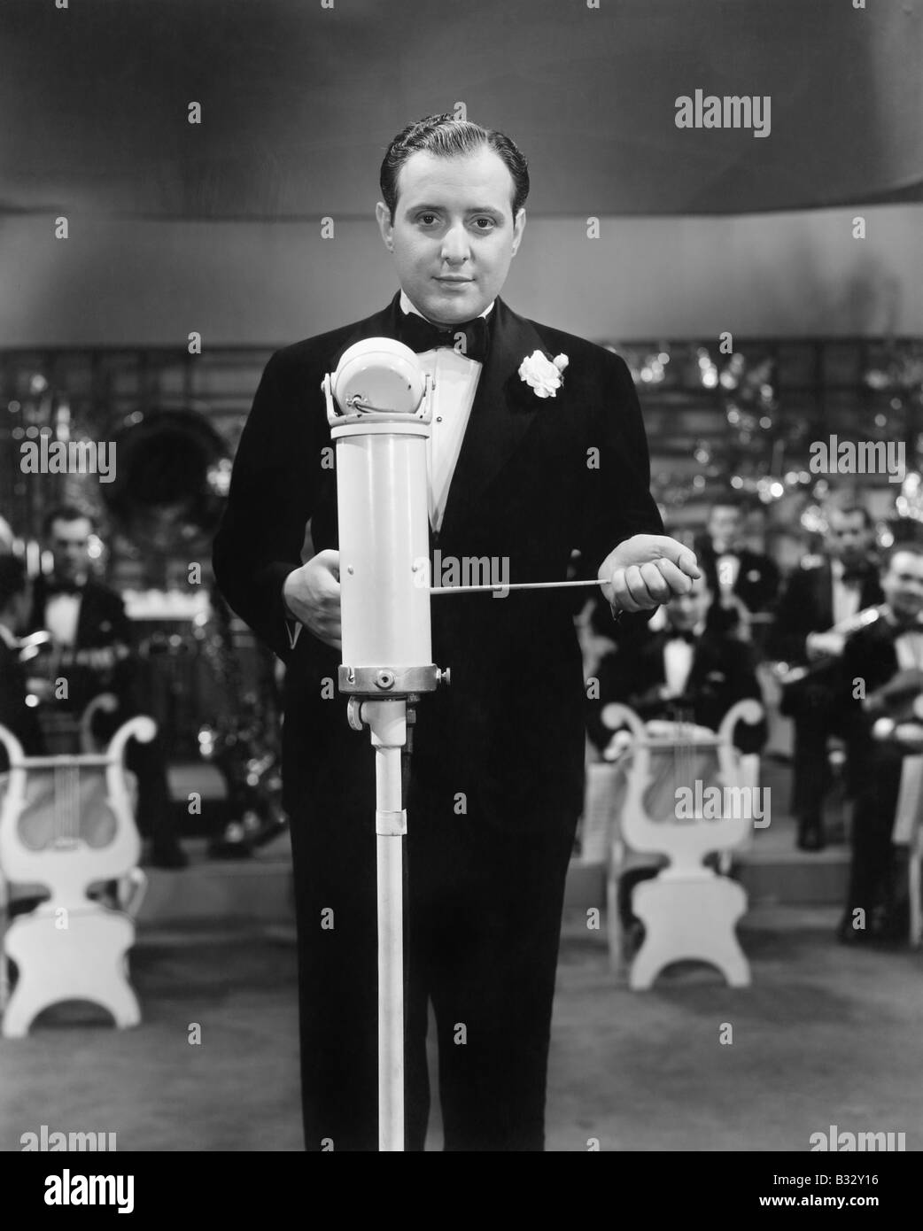 Conductor standing in front of his orchestra with a baton Stock Photo ...