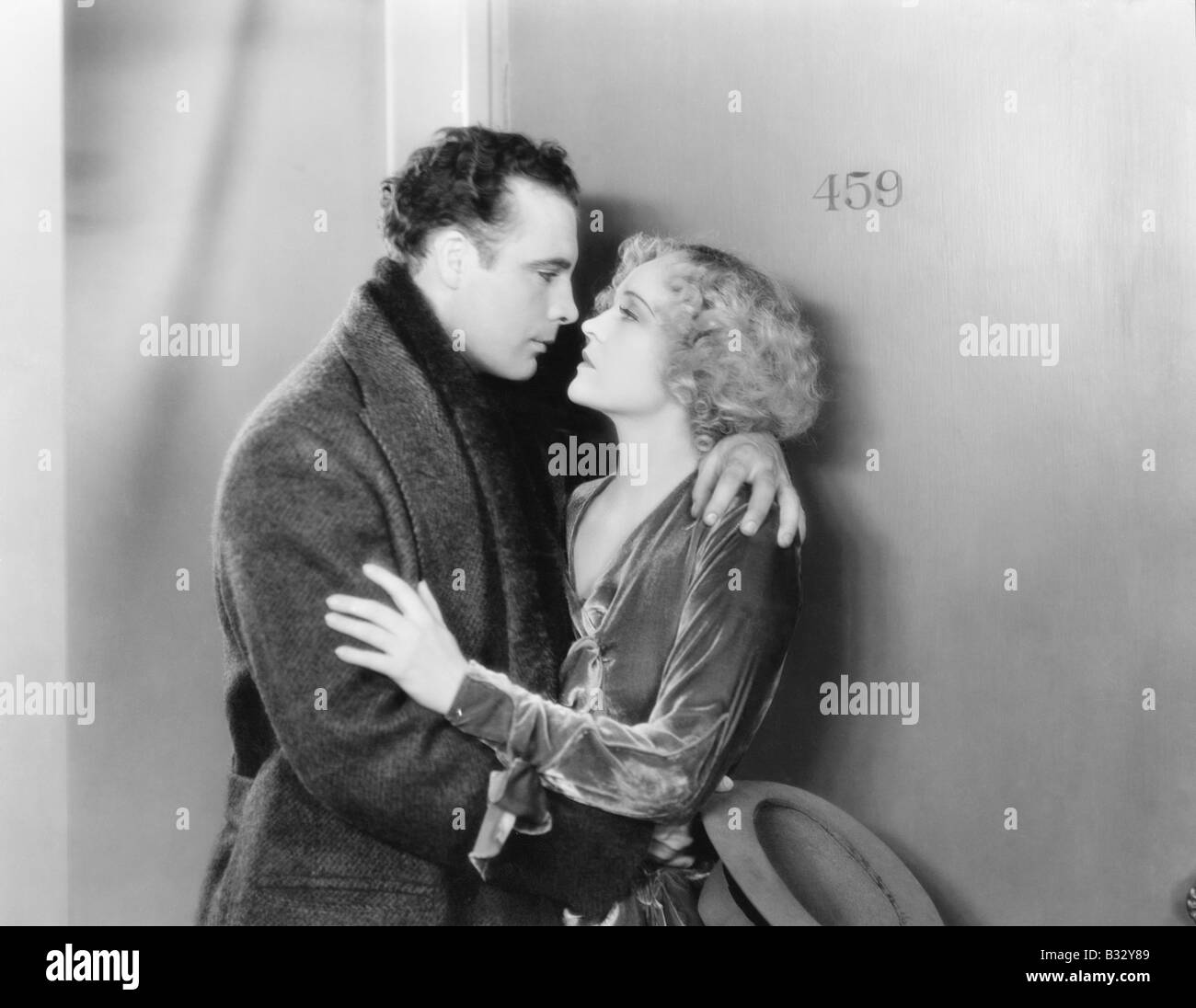 Couple almost kissing outside the front door Stock Photo - Alamy