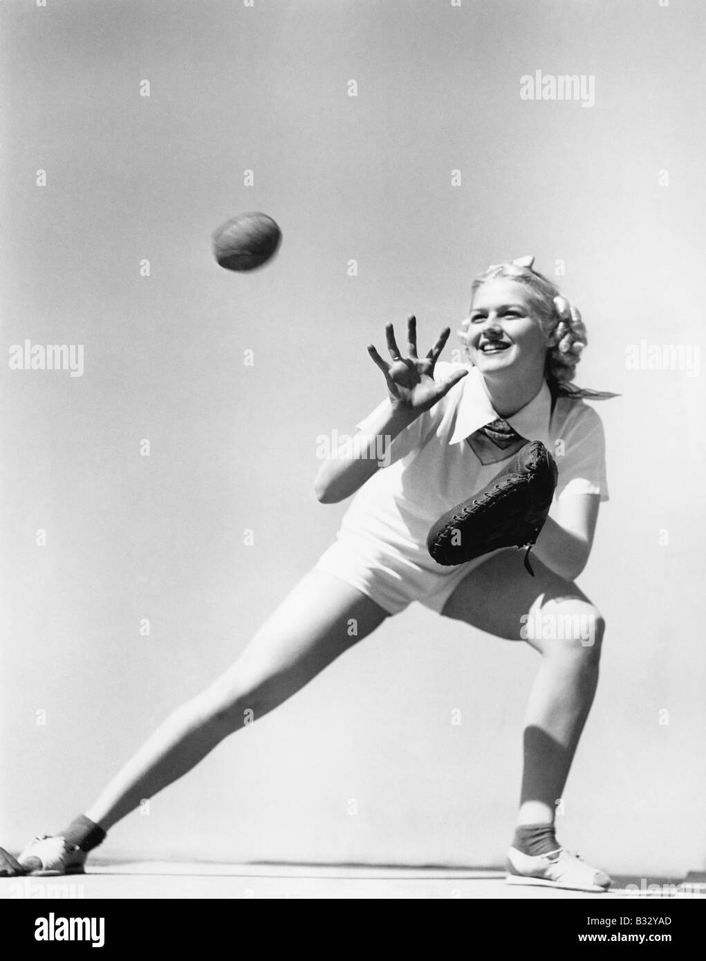 Woman catching a baseball Stock Photo - Alamy