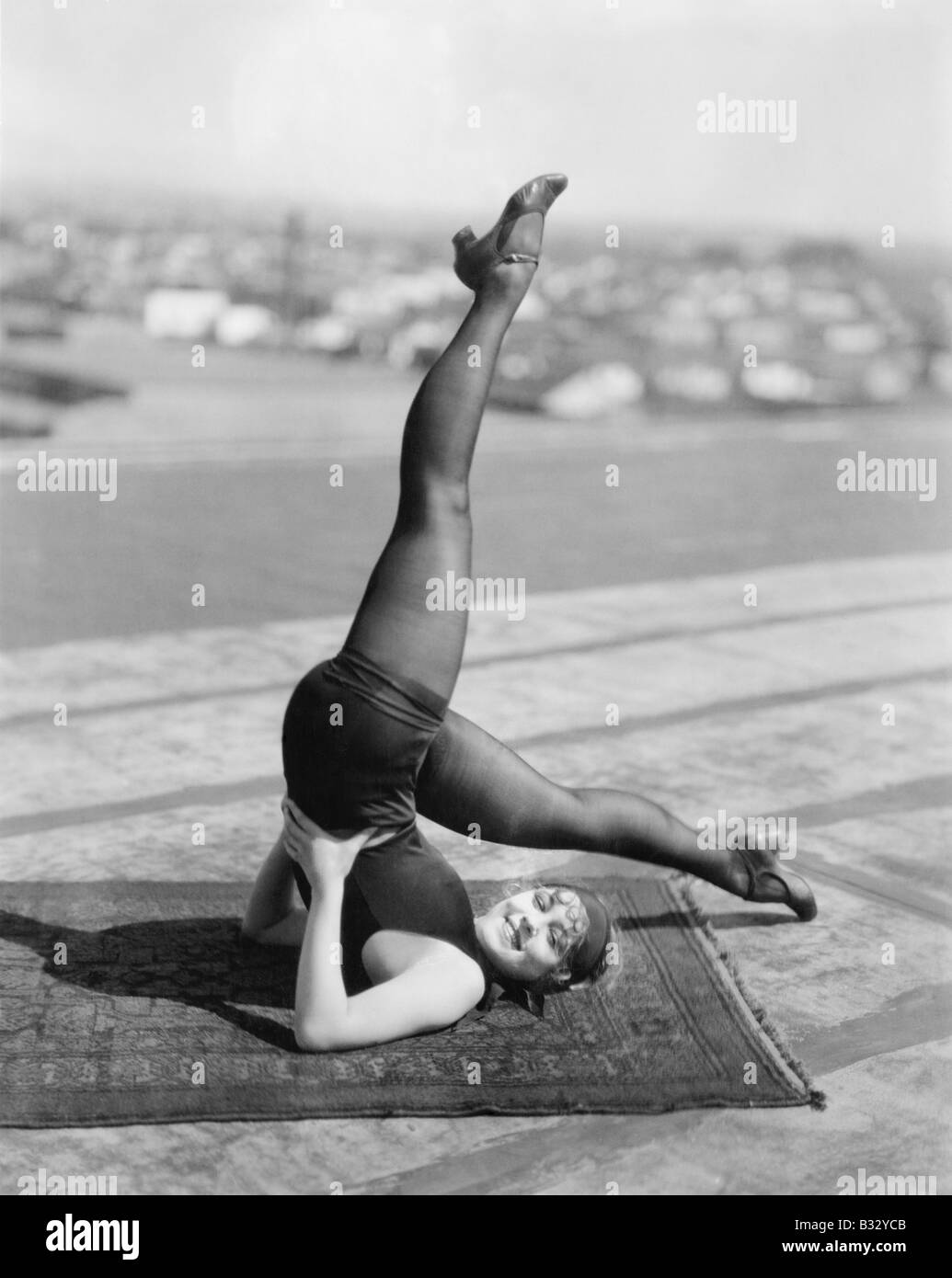 Woman lying on a rug doing her exercise Stock Photo - Alamy