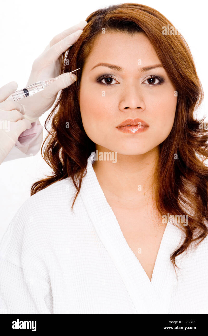 A young woman is about to have an injection in her forehead Stock Photo ...