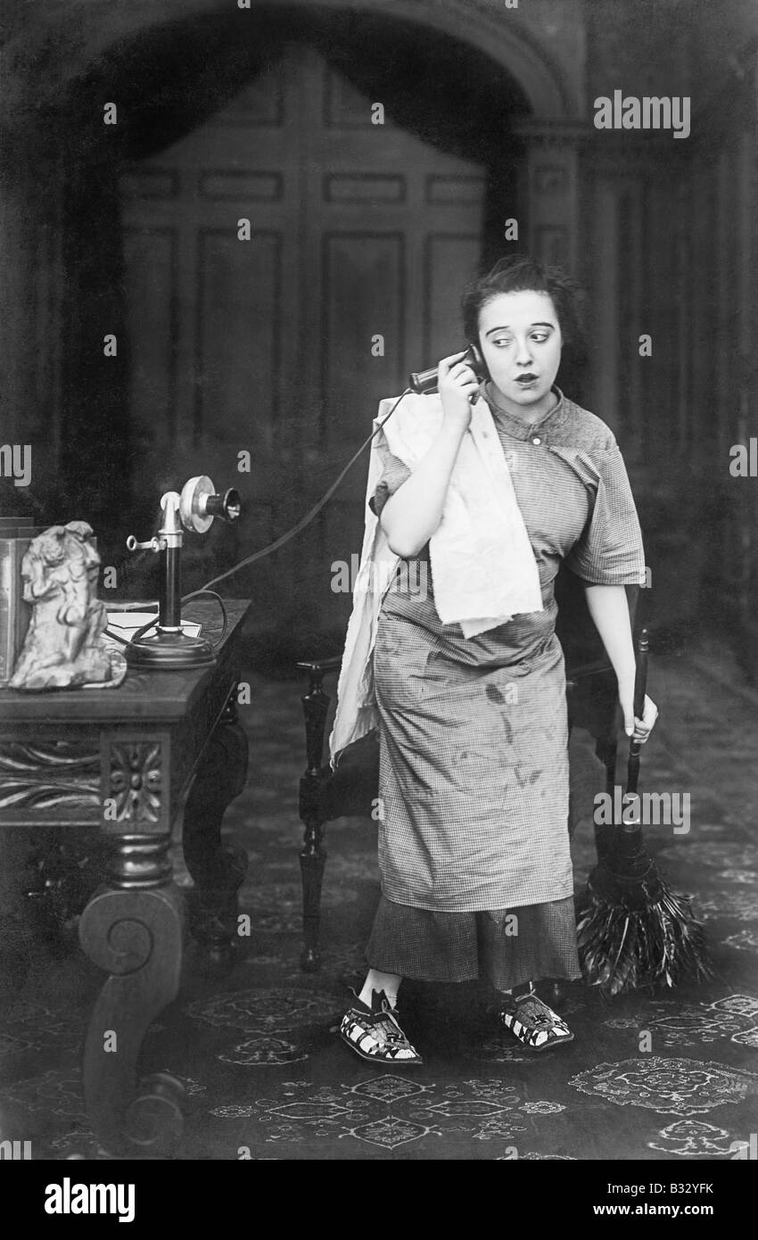 Housekeeper looking disheveled listening on the telephone Stock Photo ...