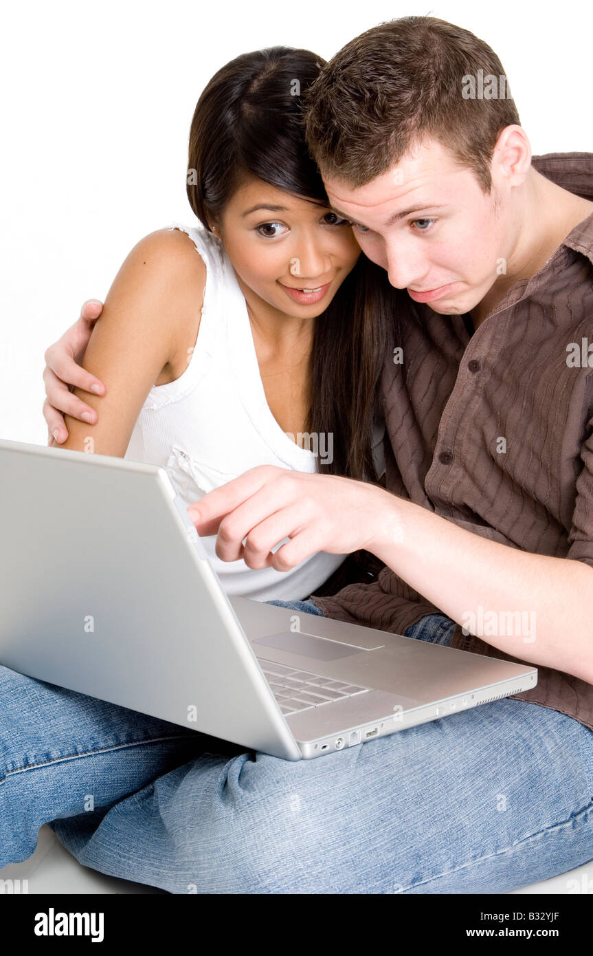 A young couple pointing at the screen of a laptop computer Stock Photo ...