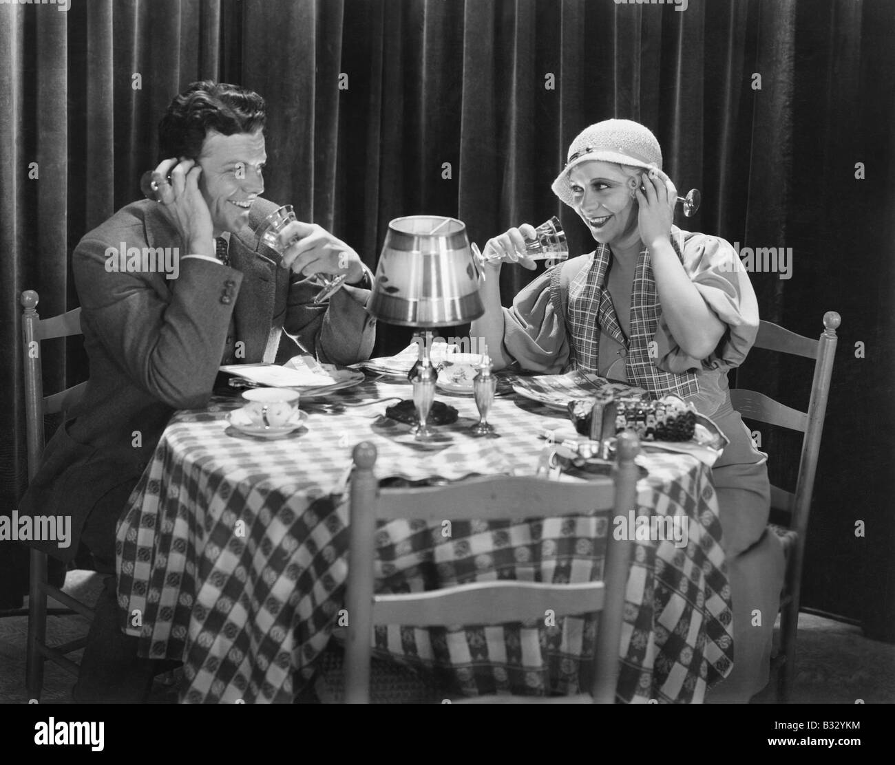 Smiling woman dining table Black and White Stock Photos & Images - Alamy
