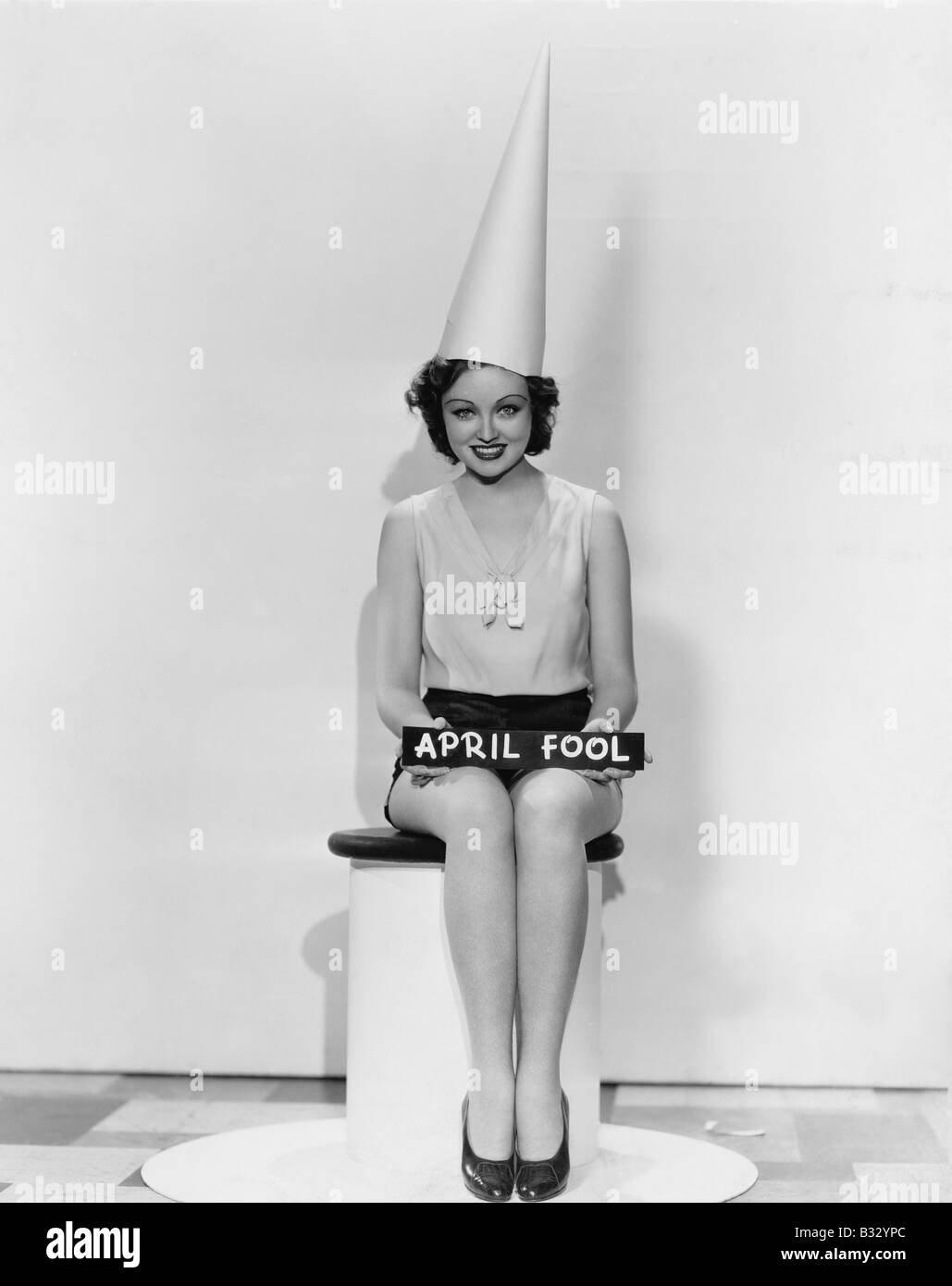 Portrait of woman with April Fool sign wearing dunce cap Stock Photo ...