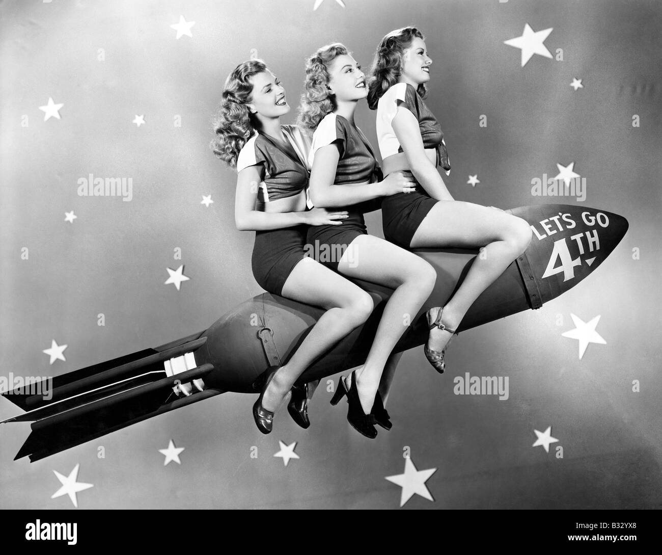 Three women sitting on a rocket Stock Photo - Alamy