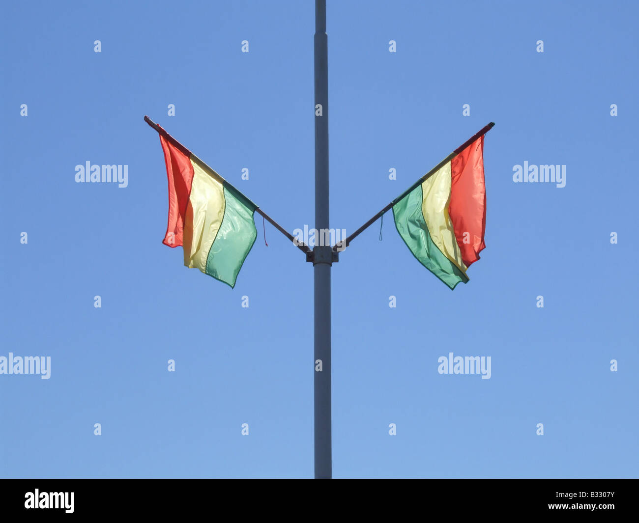 two colourful flags banners on pole post in italy Stock Photo - Alamy