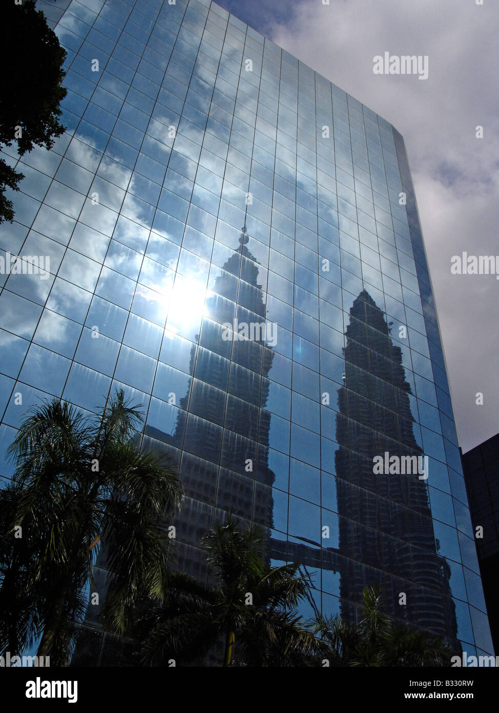 Reflections of the Petronas Twin Towers in a glass facade, Kuala Lumpur ...