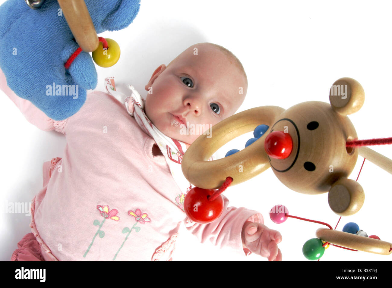 baby girl playing with trapeze toys Stock Photo - Alamy