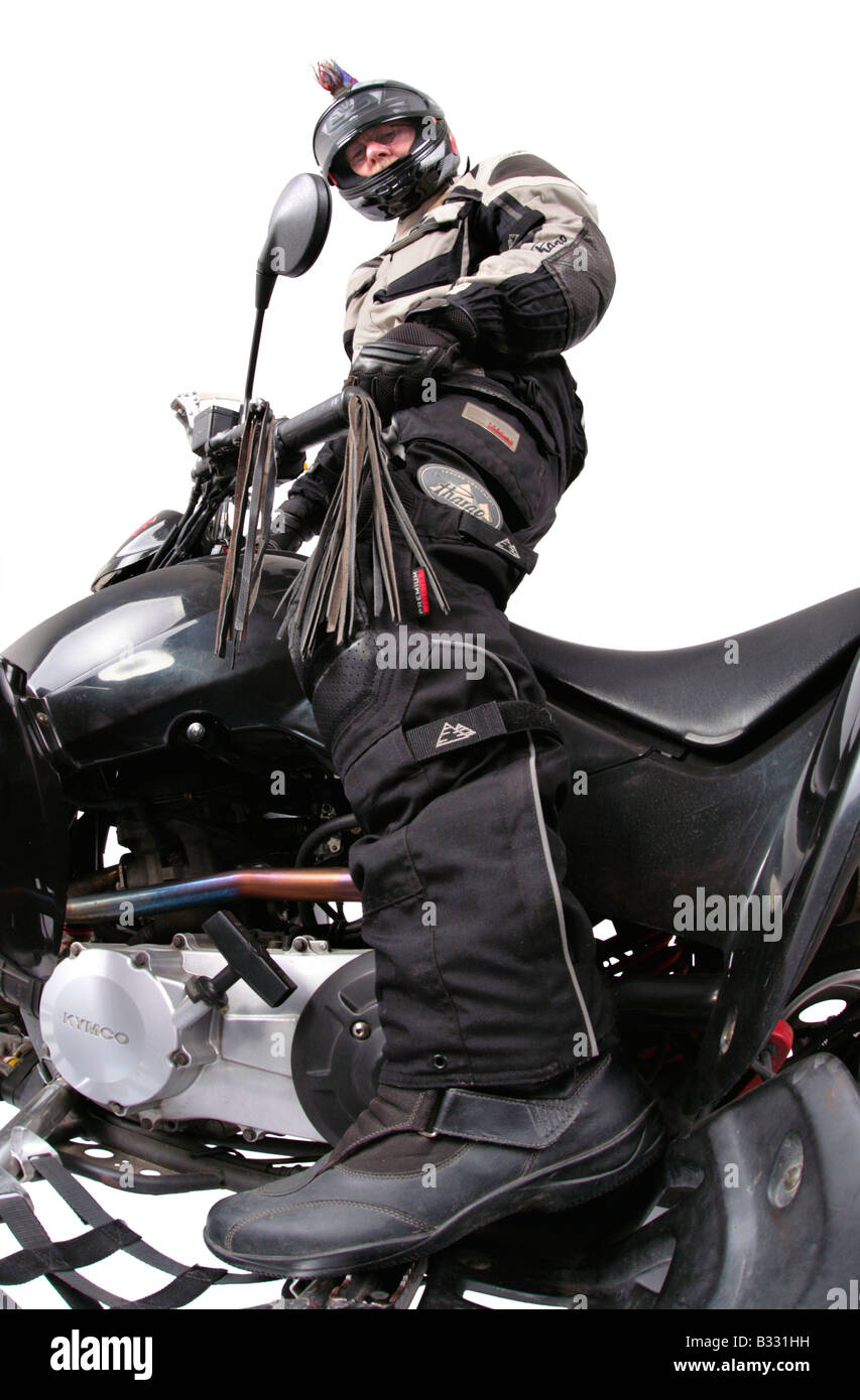 quod biker with helmet and vehicle Stock Photo - Alamy