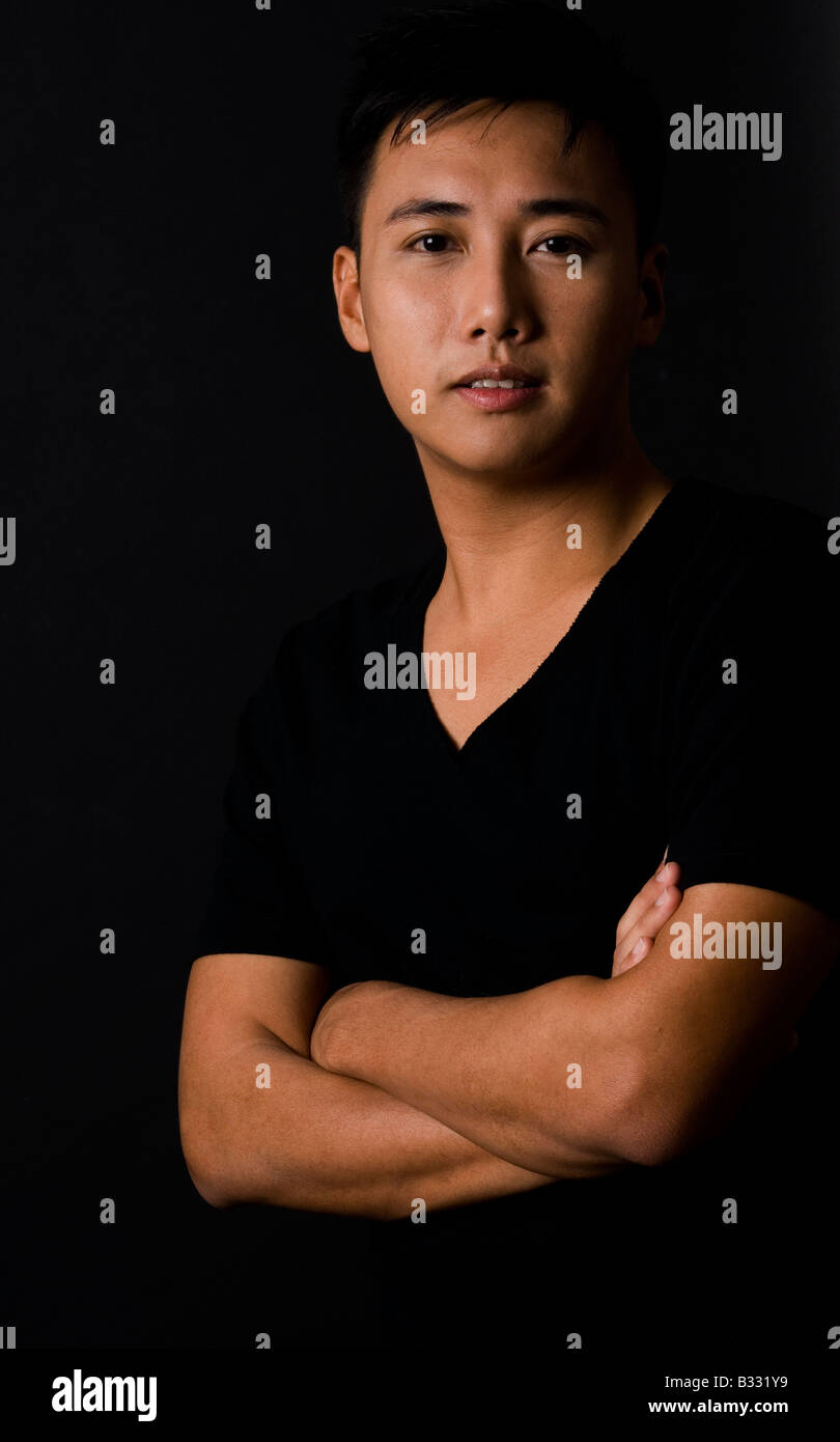 A smiling male model in black Stock Photo - Alamy