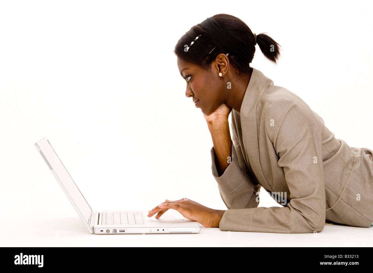 a young black woman in business suit using a laptop computer on the ...