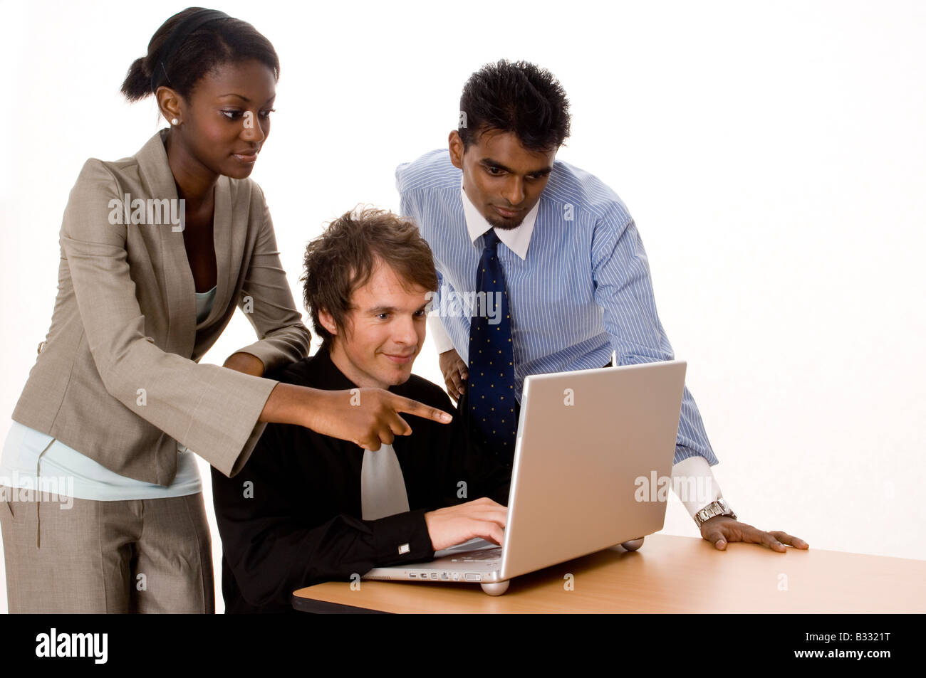Three people working on a silver laptop computer Stock Photo - Alamy